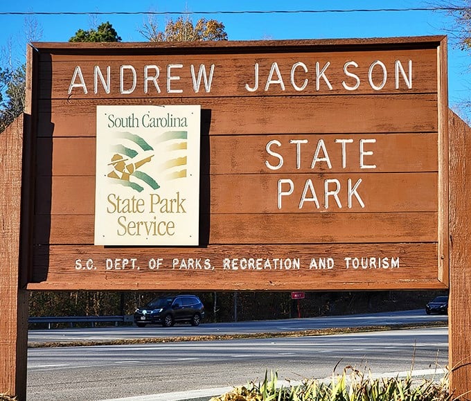 The park's wooden entrance sign stands as a rustic gatekeeper to history and nature – less "theme park spectacular" and more "genuine South Carolina charm."