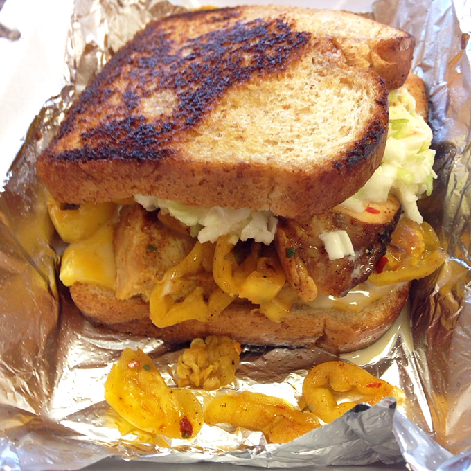The smoked turkey sandwich—proof that even poultry can achieve greatness when introduced to wood smoke and nestled between properly toasted bread with melty cheese.