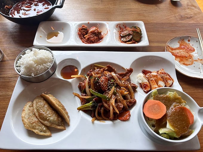This isn't just a meal, it's a flavor geography lesson – each compartment offering a different region of Korean culinary brilliance.