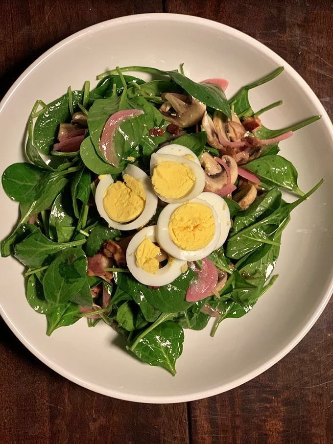 Even salads get the star treatment – fresh spinach, perfectly boiled eggs, and what appears to be house-smoked bacon create a bowl that even carnivores will respect.