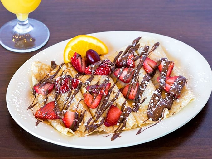 Strawberry and Nutella crepes that make you wonder why we don't eat dessert for breakfast more often. The orange slice is there for "balance."