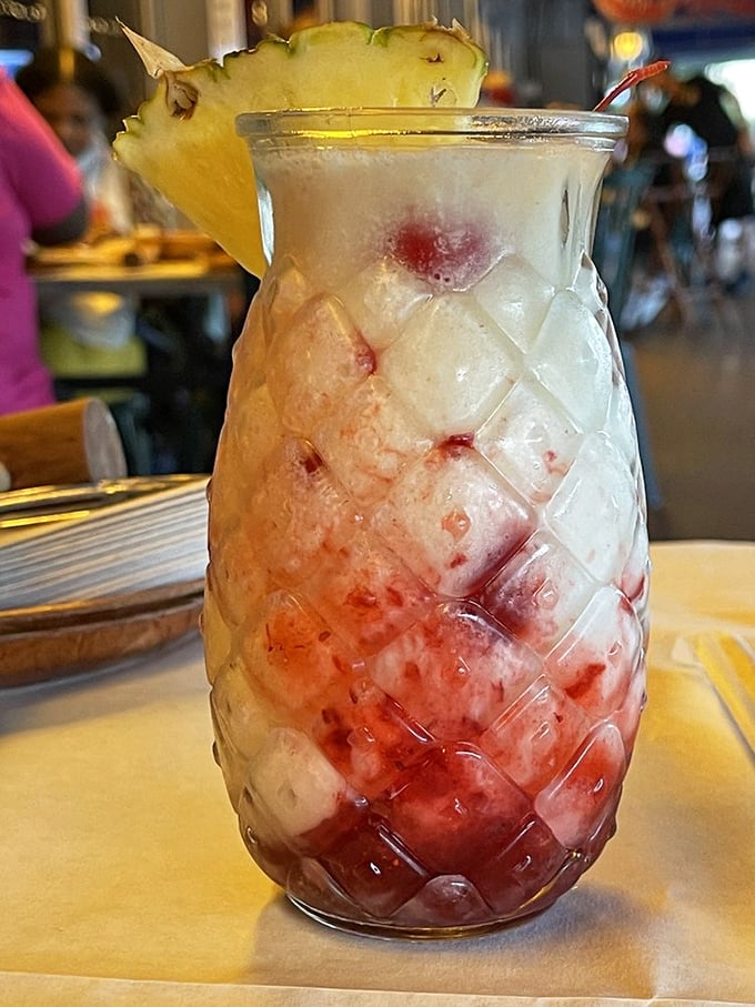 A pineapple-garnished tropical concoction in a diamond-patterned glass—like Florida vacation vibes distilled into liquid form.
