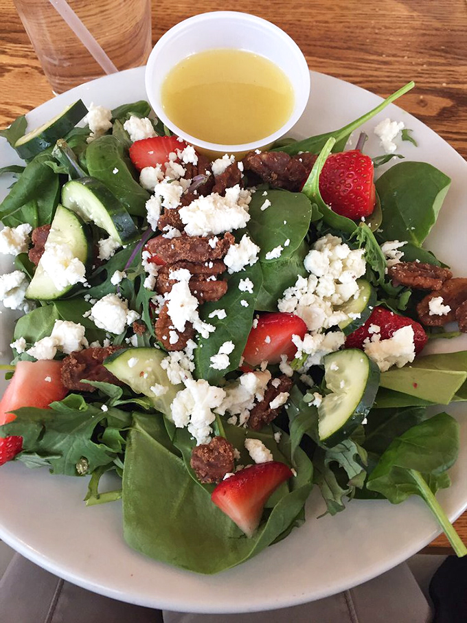 A salad that people actually crave—fresh greens, strawberries, feta, and candied nuts that make eating vegetables feel like breaking the rules.