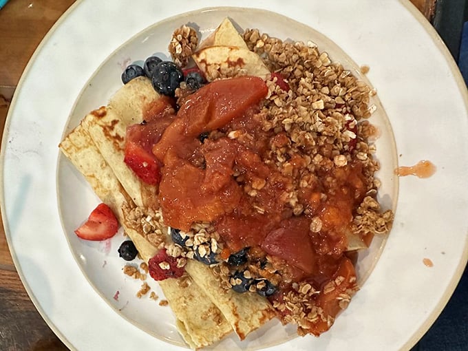 Crepes adorned with fresh berries, granola, and fruit compote—the breakfast equivalent of wearing a ball gown to the grocery store. Gloriously excessive. 