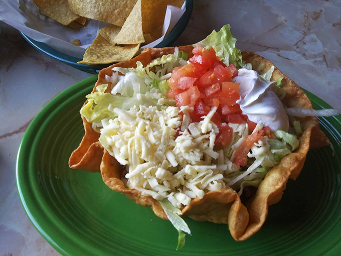 This taco salad bowl isn't just edible – it's architectural genius that answers the eternal question: "Why can't all dishes be made of fried tortilla?"