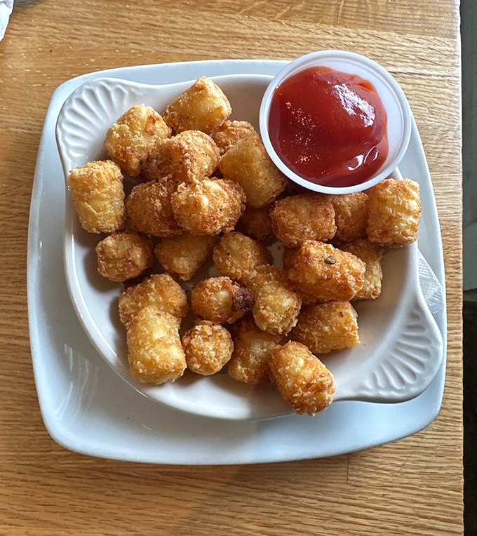 Tater tots—childhood nostalgia upgraded for your adult palate. Crispy golden nuggets that prove some pleasures never outgrow their appeal.
