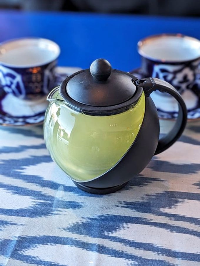 The tea service isn't just a beverage—it's a ritual, served in traditional patterned cups that warm both hands and spirit.