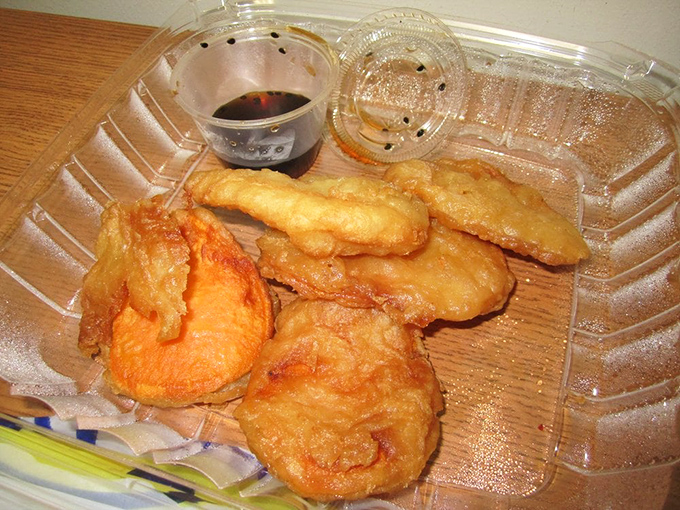 Tempura potatoes that shatter with each bite, revealing fluffy interiors. The dipping sauce is non-negotiable – use it liberally.