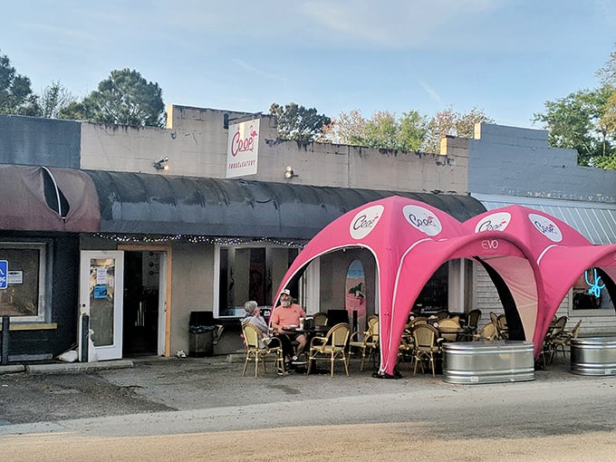 Poe's Tavern isn't just serving burgers – it's serving atmosphere. Those pink canopies aren't just for shade; they're setting the stage for island memories.
