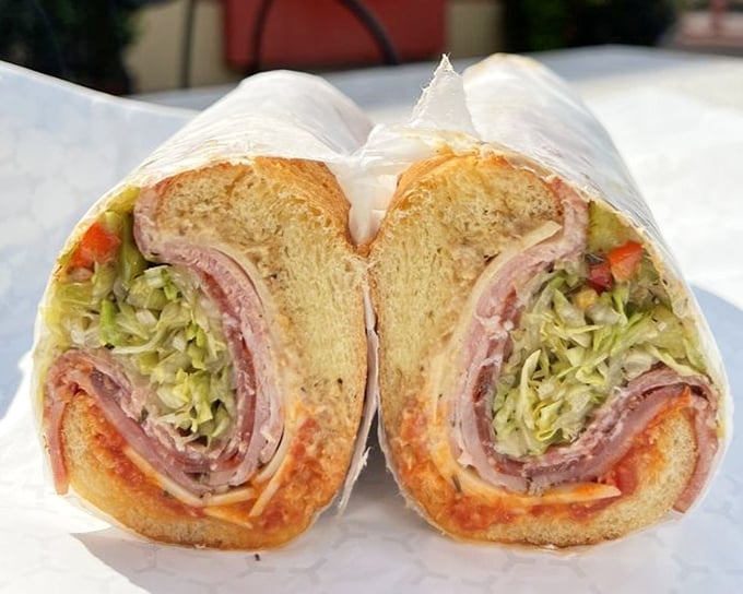 This cold cut sandwich is architecture you can eat—layers of meat and veggies creating a colorful, textural masterpiece between bread.