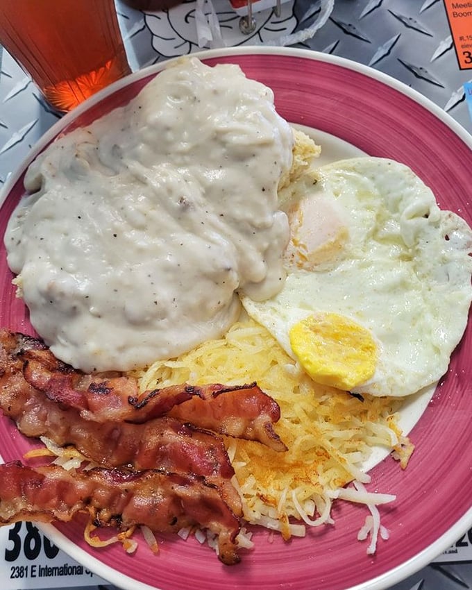 Breakfast with attitude—crispy bacon, eggs, and hash browns under a blanket of country gravy that's practically tucking you in.