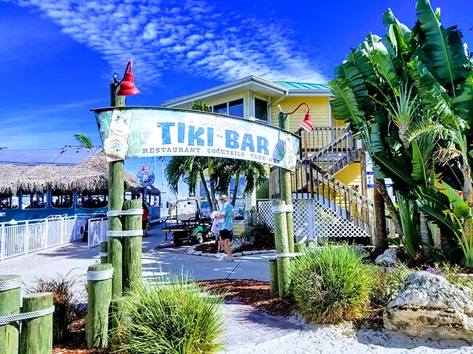 The Tiki Bar's entrance promises the kind of laid-back Florida experience where flip-flops are formal wear and sunset-watching qualifies as entertainment.