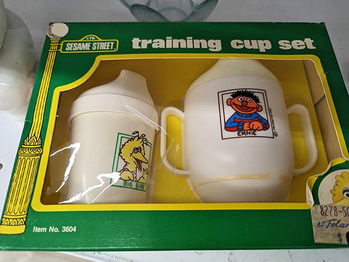 Vintage Sesame Street training cups—Big Bird and Ernie ready to help with toddler transitions. Nostalgic parenting at bargain basement prices!