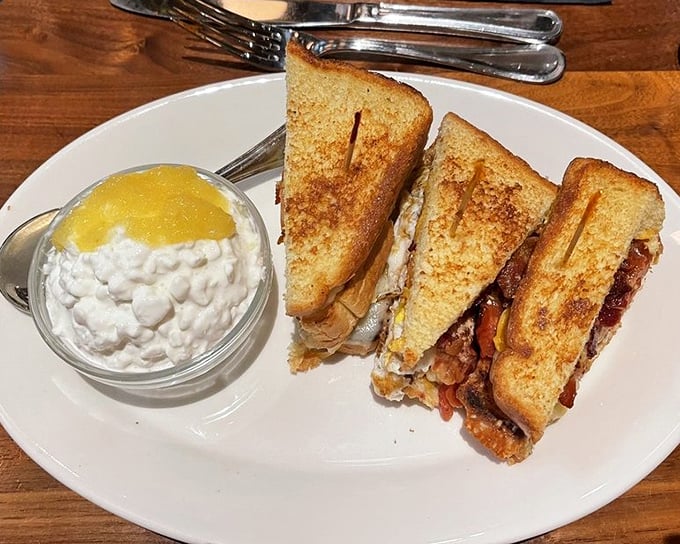 This sandwich isn't messing around—triple-decker construction with layers that require both hands and absolutely zero shame.