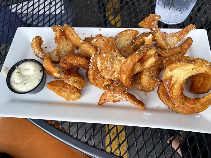 These aren't just onion rings – they're golden halos of crispy perfection that make you wonder why anyone would ever choose regular fries.