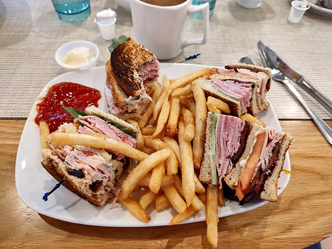 The club sandwich – stacked higher than winter snow drifts – stands as a monument to the art of proper lunch construction.