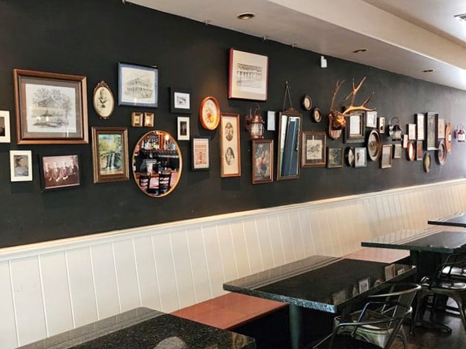 The gallery wall isn't just decoration—it's a visual history lesson that gives you something to admire while waiting for your meat sweats to subside.