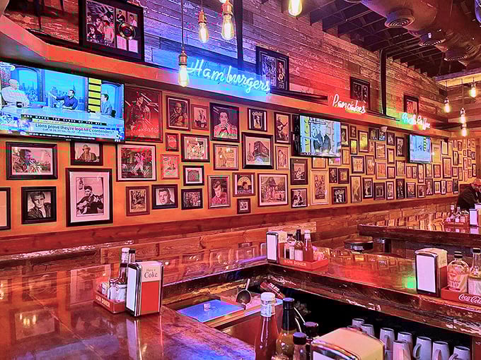 The wall of fame showcases music legends while neon signs glow overhead—dining under the watchful eyes of rock and country royalty.