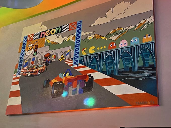 This mural captures gaming's essence perfectly—Pac-Man ghosts and racing checkered flags coexisting in pixel-perfect harmony.