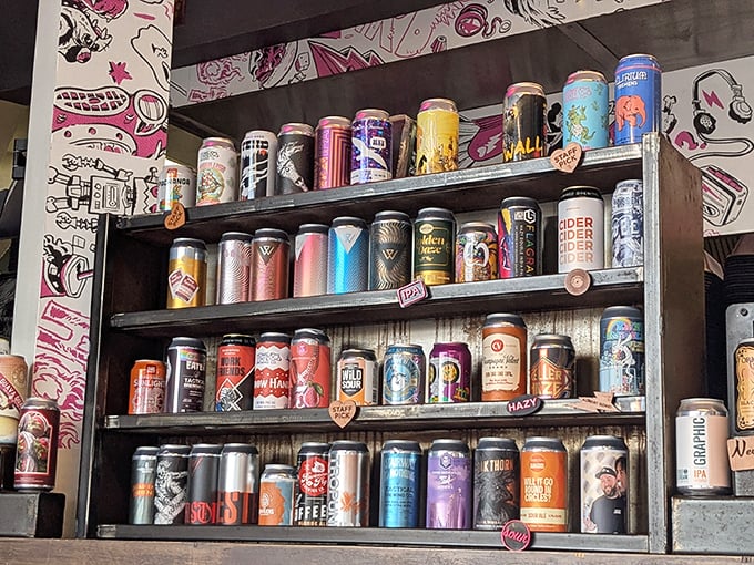 The craft beer wall—a colorful, aluminum art installation that pairs perfectly with spicy chicken and questionable life decisions.