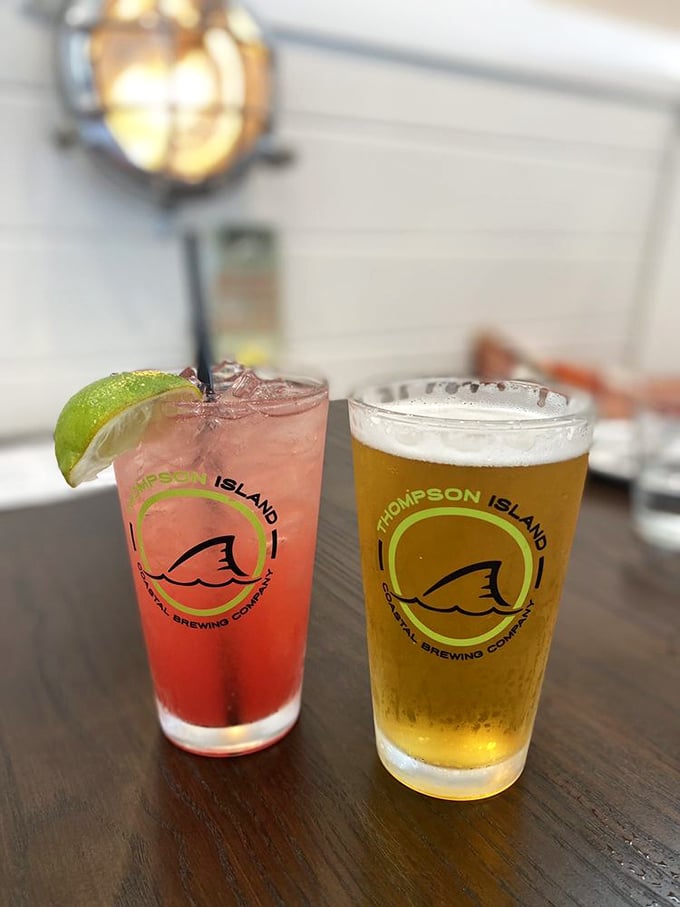 Cocktails and craft beer—because nothing says "I'm on vacation" quite like a watermelon drink with a lime hat and a golden brew companion.