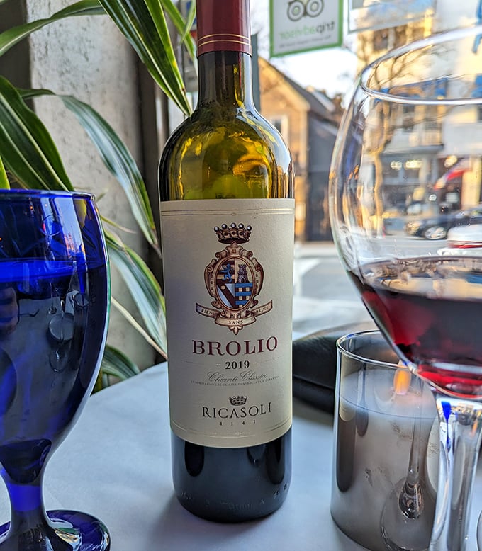 A bottle of Brolio Chianti Classico—because what's an Italian feast without the perfect wine companion? Those blue glasses add the perfect dramatic touch. 