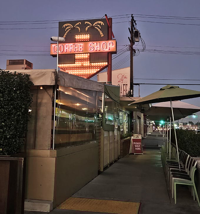 Even after dark, that iconic coffee shop sign glows like a beacon for late-night comfort seekers.