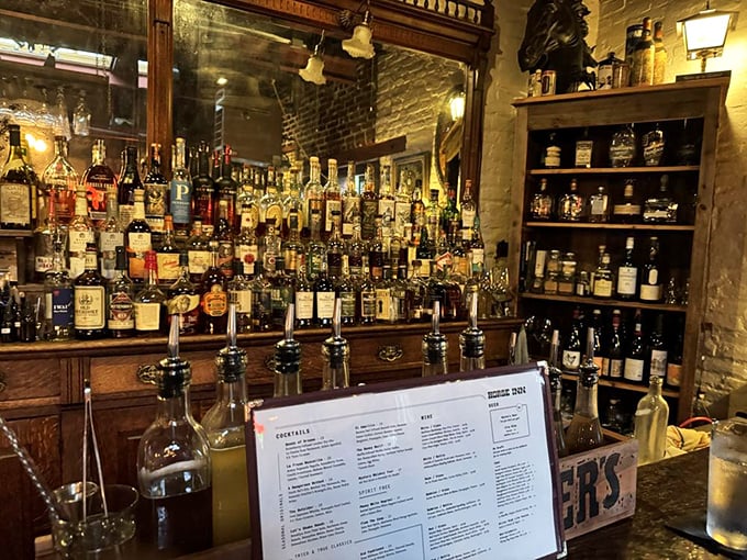Behind this bar, mixology becomes art – bottles standing at attention like soldiers ready to be deployed in the battle against ordinary drinks.