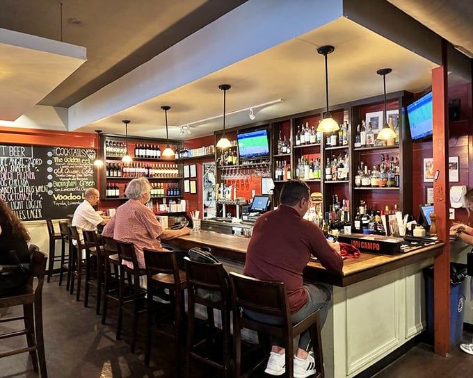 The bar area balances sports-watching practicality with cocktail-sipping sophistication – a rare achievement in burger joint design.