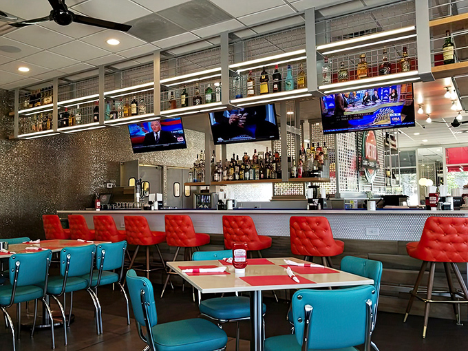 The bar doesn't just serve drinks – it showcases them like the Metropolitan Museum of Mixology, with red chairs inviting you to become a patron.