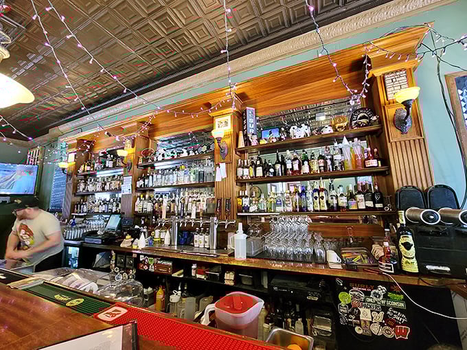 A bar stocked with enough options to make decision-making the hardest part of your visit. Those string lights aren't just decorative—they're mood medicine.