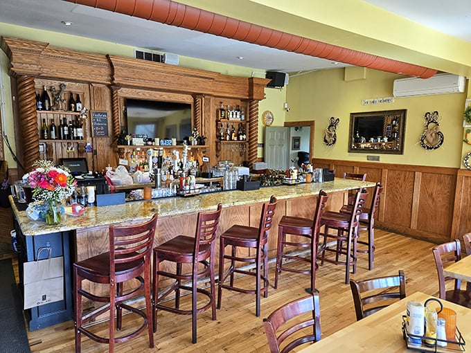 The bar area's warm wood tones and granite countertop create the perfect stage for both serious conversations and spontaneous laughter.