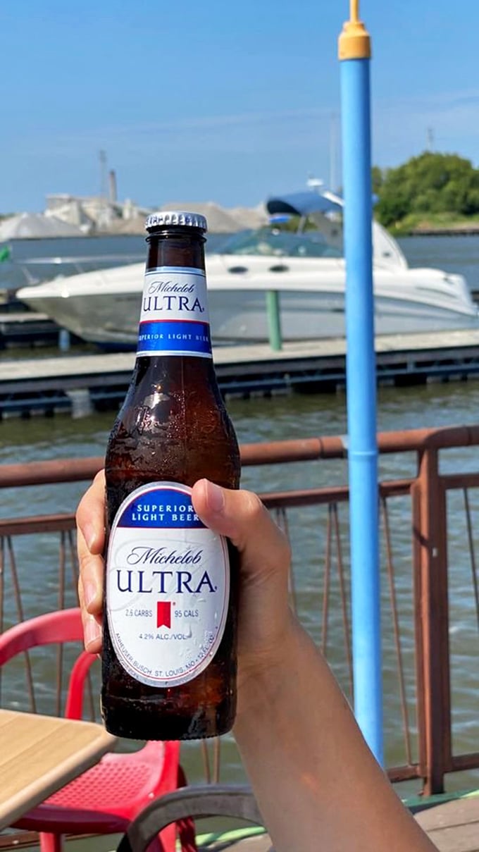 Nothing completes the waterfront dining experience like a cold beer with boats bobbing in the background – simple perfection.