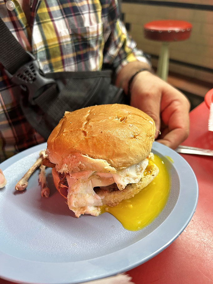 The breakfast sandwich that breaks all the rules – egg yolk cascading down the side, meat and cheese in perfect harmony, served on a bun that means business.