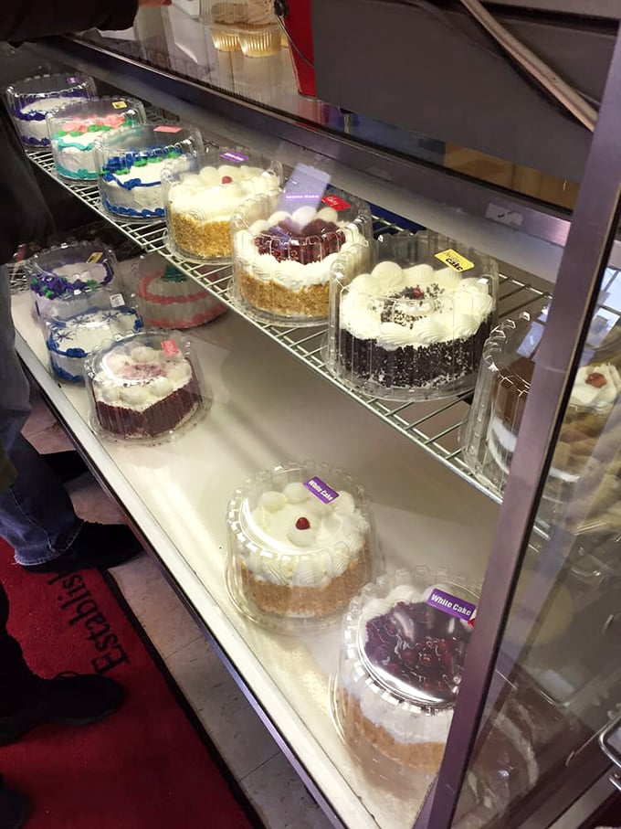 Layer cakes standing proud behind glass, like celebrities at their own premiere. Each one promises a different path to dessert nirvana.