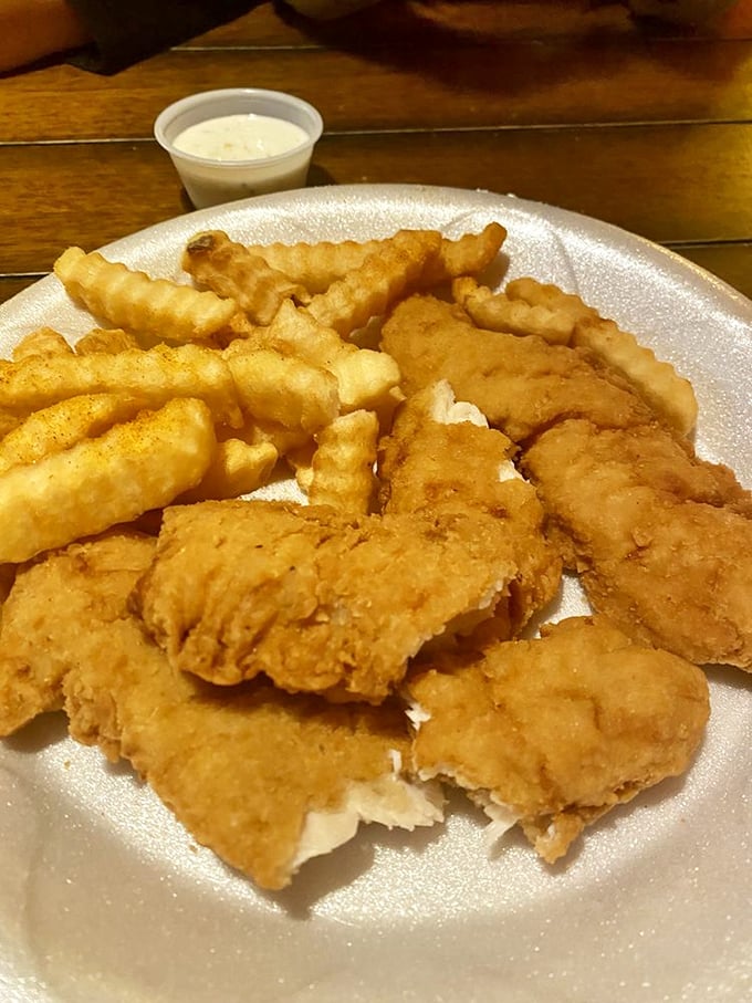 Golden-fried chicken tenders that shatter with each bite, paired with fries that deserve their own fan club.