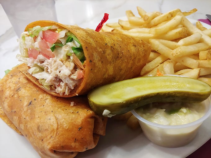 The humble wrap elevated to art form – crispy on the outside, creamy-crunchy within, and paired with fries that demand to be savored.
