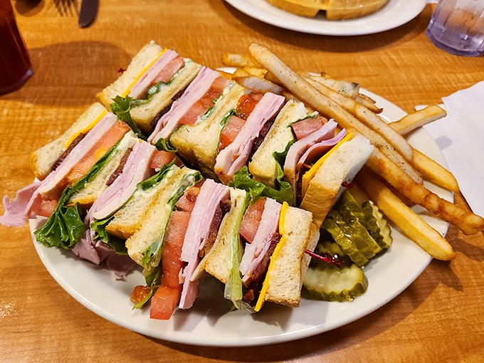 The club sandwich—three stories of deli perfection with a side of fries. Architecture you can eat, engineered by someone who understands hunger.