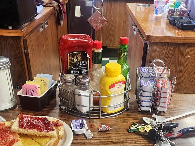 The condiment caddy—that miniature United Nations of flavor where ketchup, mustard, and hot sauce negotiate the terms of your meal's final taste.