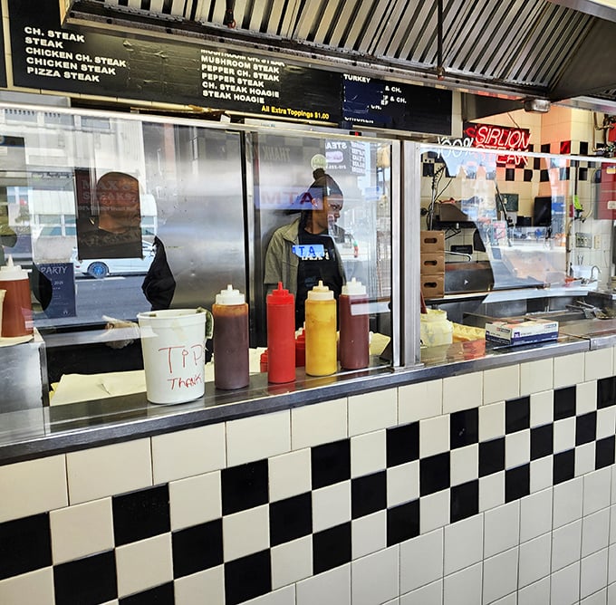 The condiment lineup stands ready for duty. Those squeeze bottles have seen more action than a Hollywood stuntman.