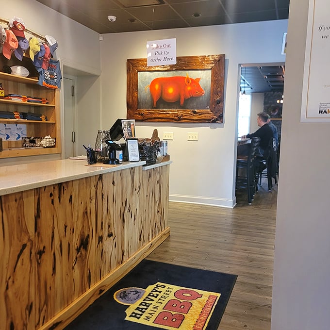 The counter where barbecue dreams come true. That pig painting isn't just decoration—it's a tribute to the star of the show.