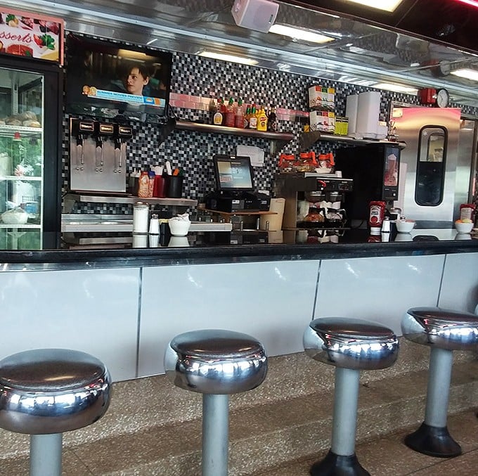 Chrome stools lined up like soldiers, ready for the next shift of hungry patrons to perch and ponder life's big questions over small plates.