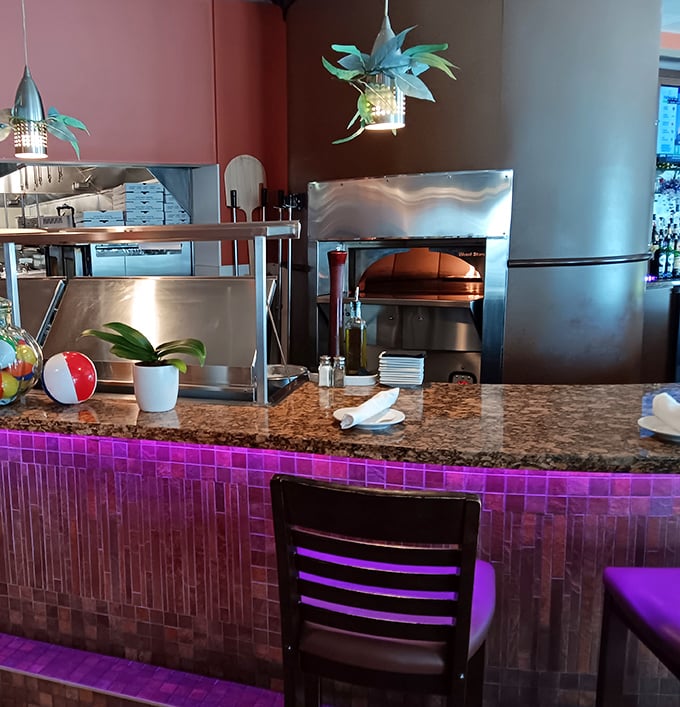 Counter seating offers front-row views of the pizza oven where magic happens daily.