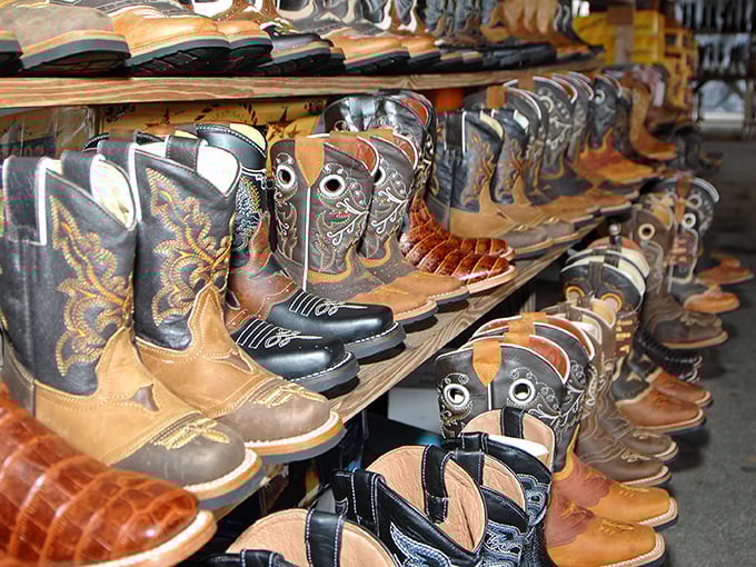 Cowboy boots lined up like leather soldiers, each pair telling a different story of dusty trails and dance floors yet to come.