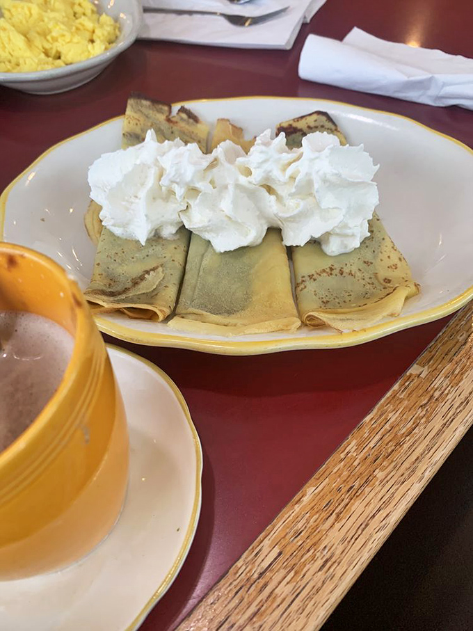 Delicate crepes with a cloud of whipped cream – the breakfast equivalent of wearing silk pajamas while watching sunrise.
