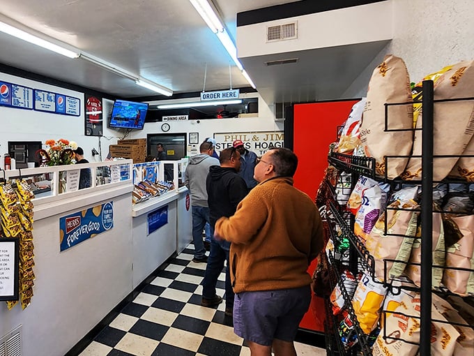 The lunch counter ballet—customers patiently waiting their turn for sandwich nirvana. Some treasures are worth the wait.
