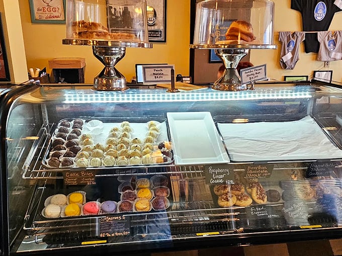 Pastry case that should come with a warning label: "May cause spontaneous happiness and inability to choose just one." Sweet temptation behind glass.