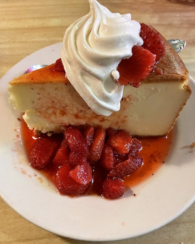 This isn't just cheesecake—it's a creamy canvas for strawberry compote and whipped cream that whispers, "There's always room for dessert."