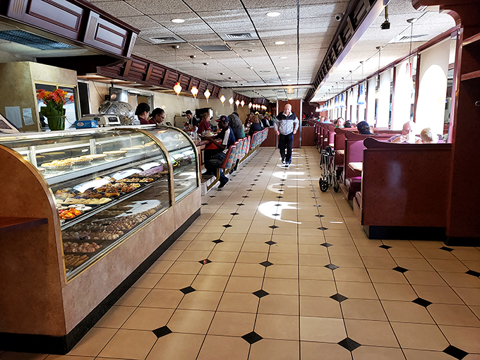 The dessert case and counter seating—where solo diners become temporary members of the extended diner family.