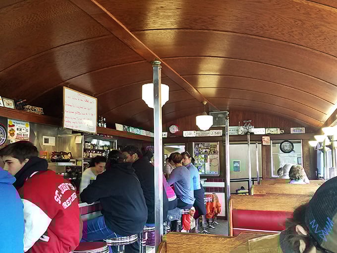 The curved wooden ceiling and counter seating create the quintessential diner experience—where regulars become family and newcomers become regulars.